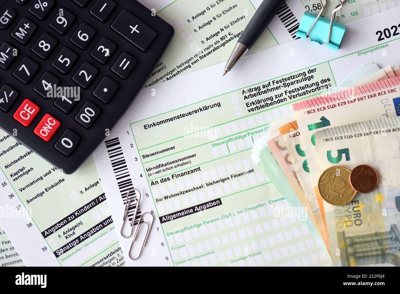 German income tax return form with pen and european euro money bills ...