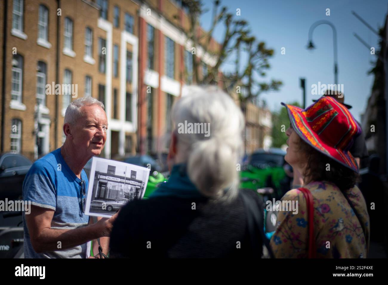 A tour guide from Meetup talking to the group in a busy street in ...