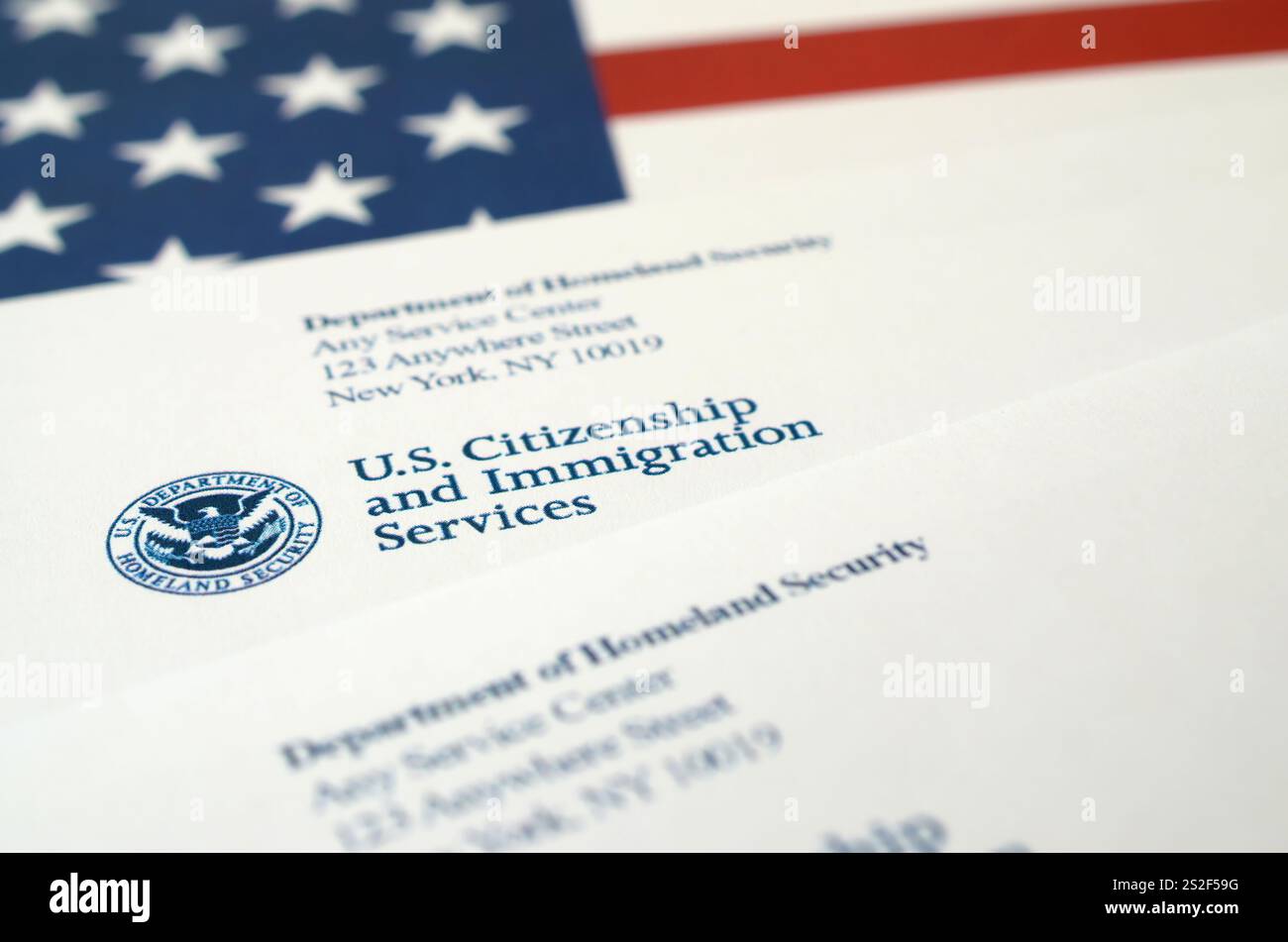 Envelopes with letter from USCIS on United States flag from Department ...