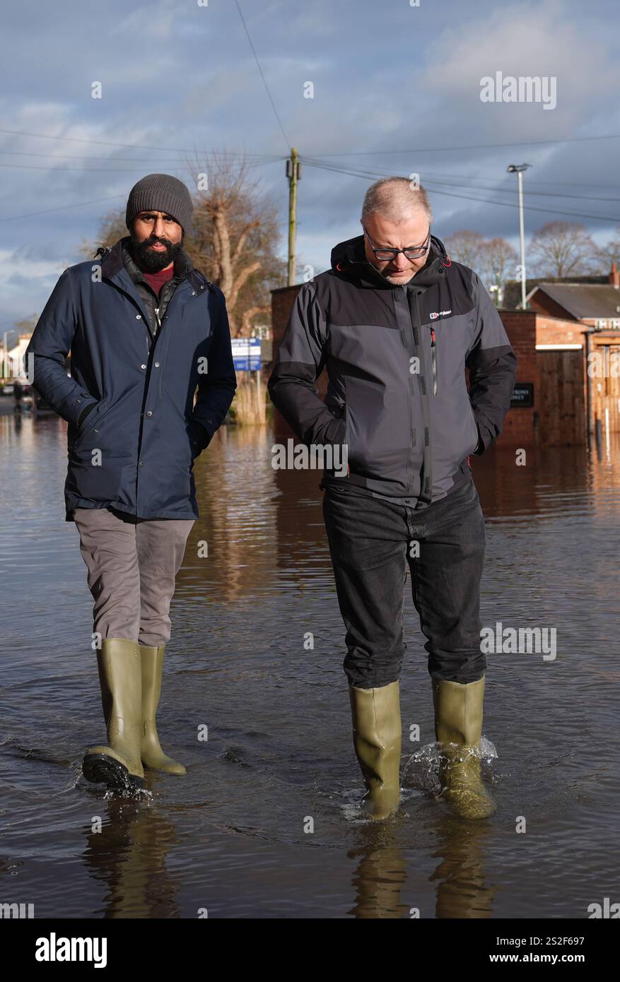 Jeevun Sandher, MP for Loughborough (left) walking through floodwater ...
