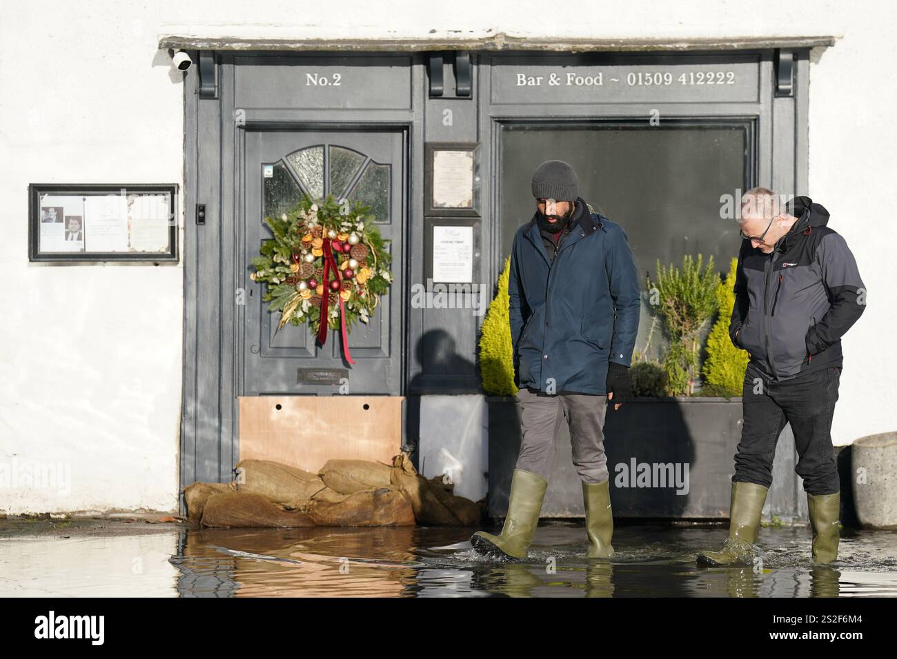 Jeevun Sandher, MP for Loughborough (left) walking through floodwater ...
