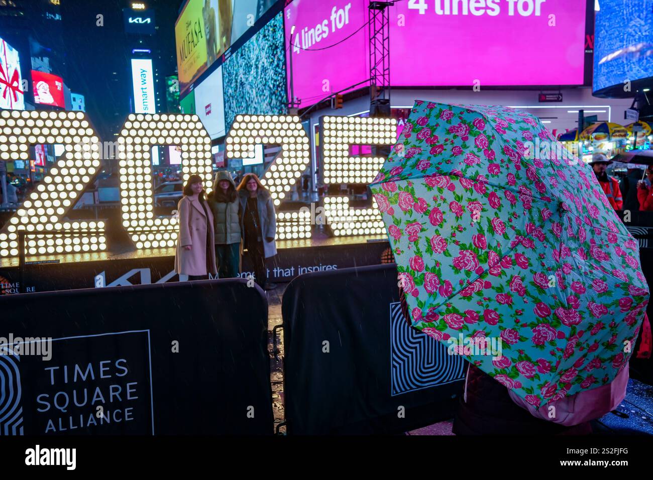 Visitors to Times Square in New York flock to the display of the “2025 ...
