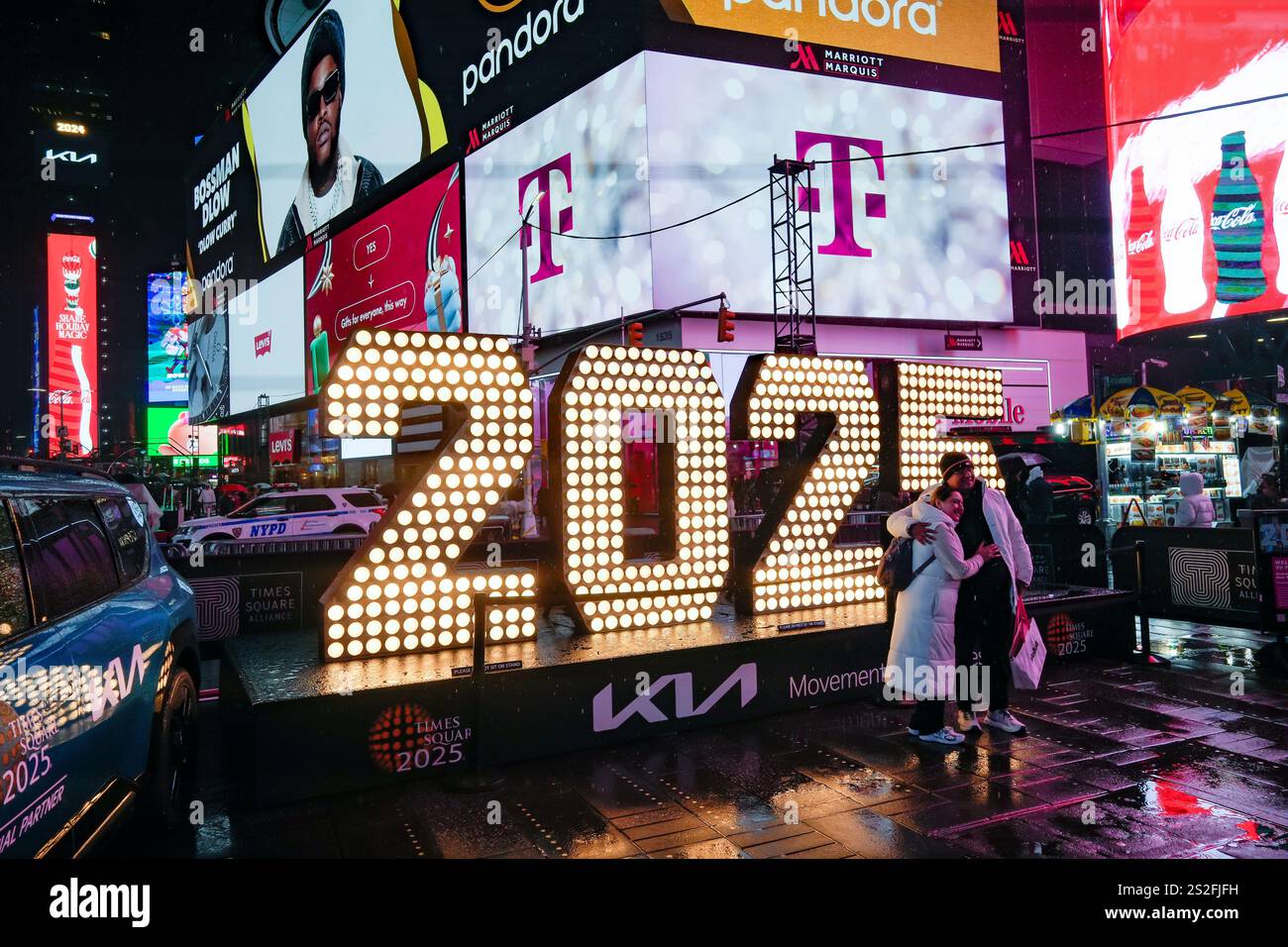 Visitors to Times Square in New York flock to the display of the “2025 ...