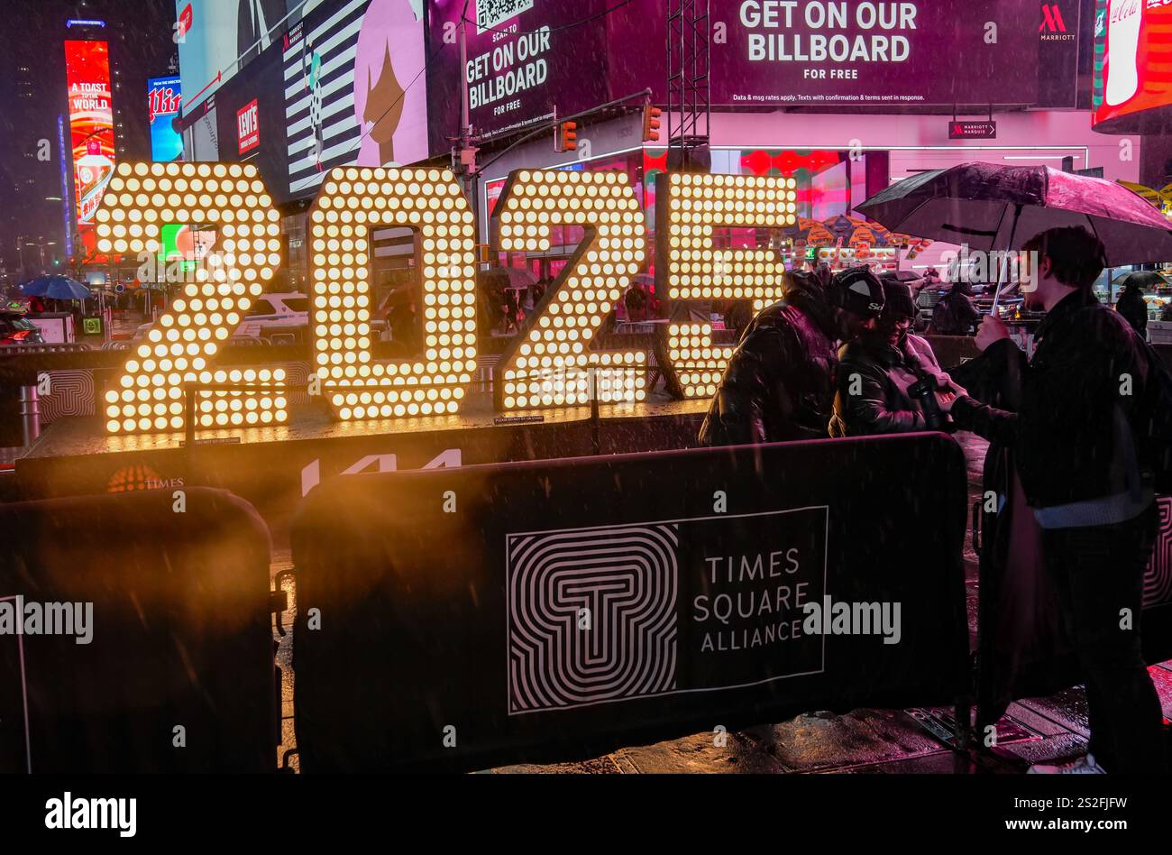 Visitors to Times Square in New York flock to the display of the “2025 ...