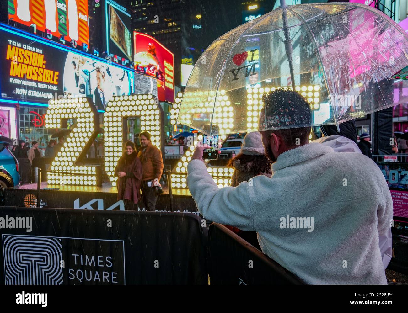 Visitors to Times Square in New York flock to the display of the “2025 ...