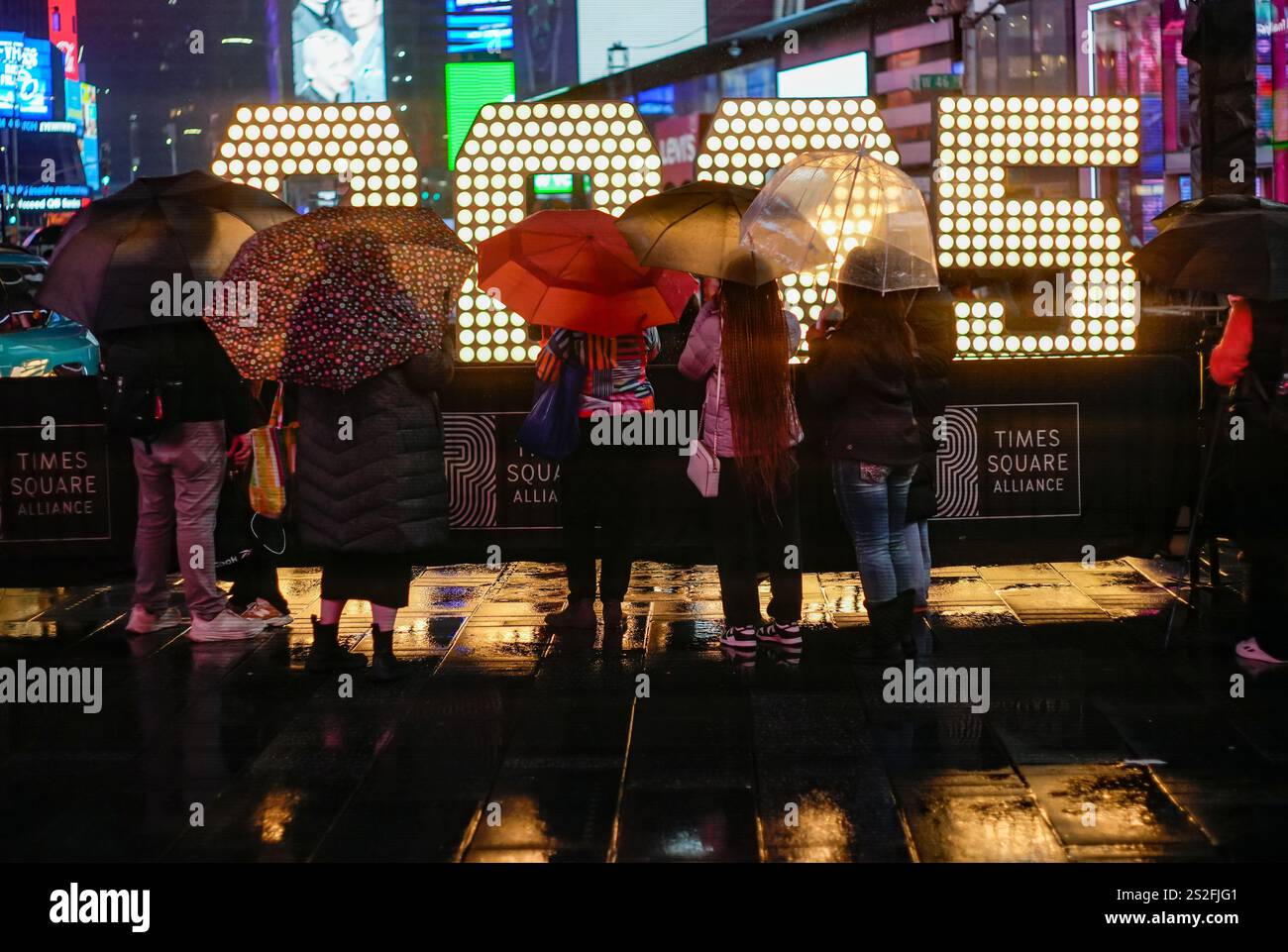 Visitors to Times Square in New York flock to the display of the “2025 ...