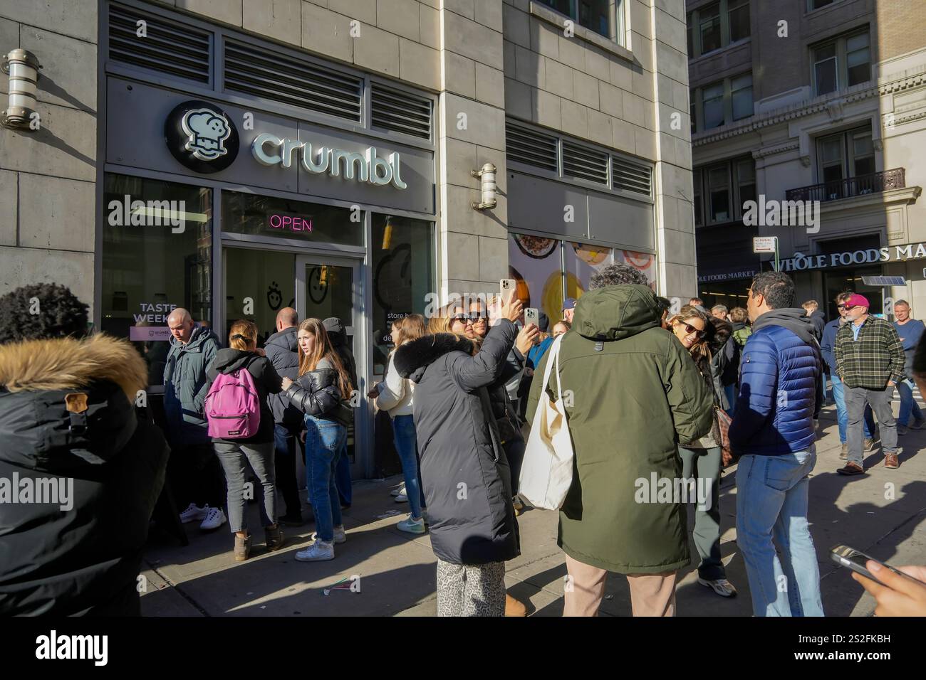 Cookie lovers line up outside the popular Crumbl store in Chelsea in ...