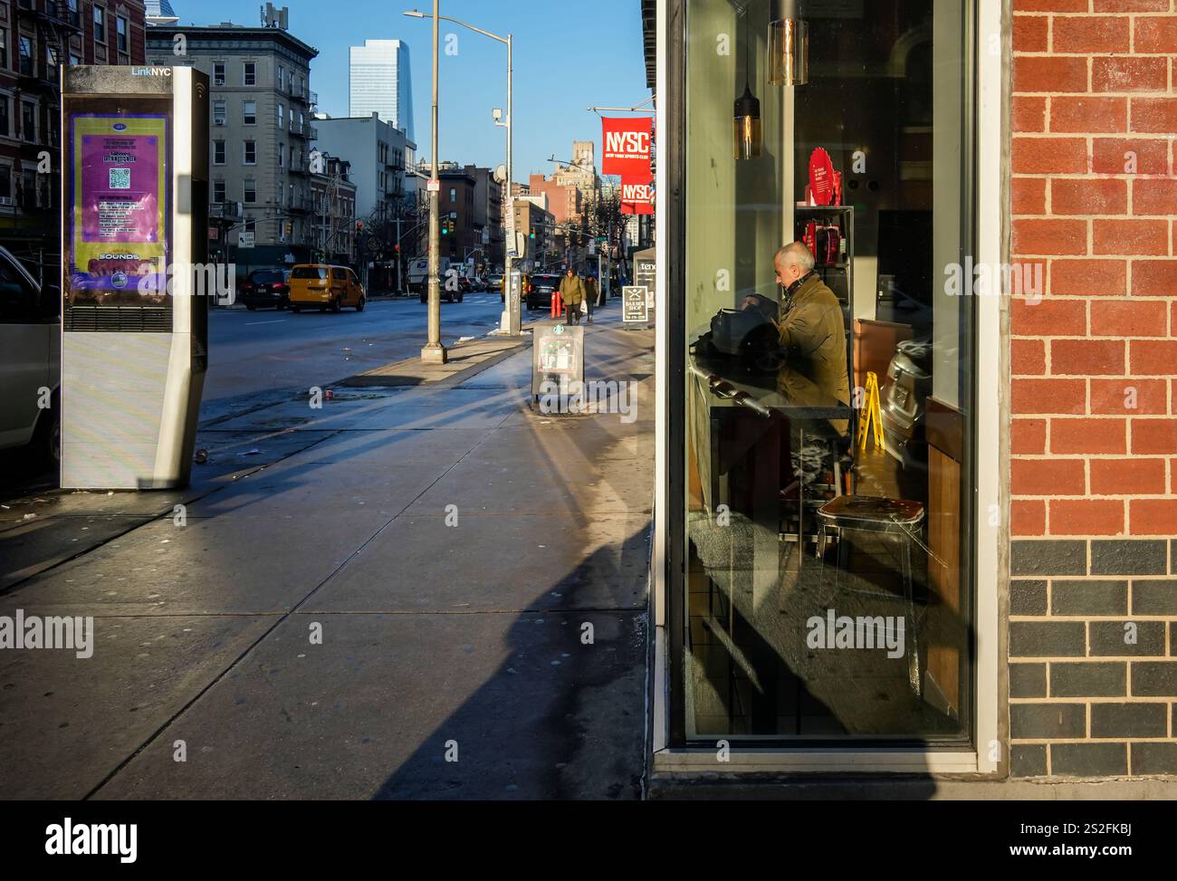 Customer sits in the window of a Starbucks in Chelsea on Christmas Eve ...