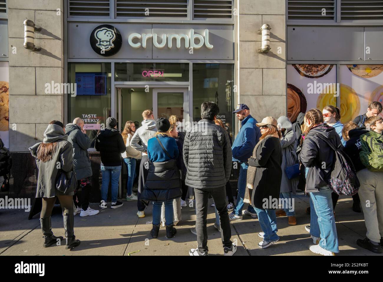 Cookie lovers line up outside the popular Crumbl store in Chelsea in ...