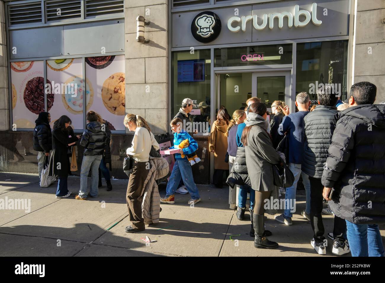 Cookie lovers line up outside the popular Crumbl store in Chelsea in ...