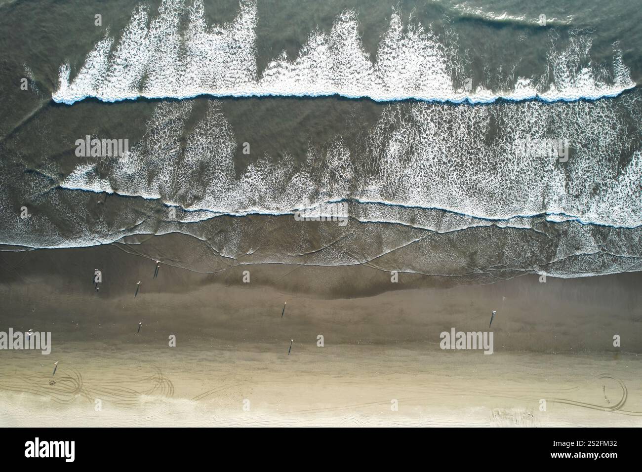 Clean beach with people and long ocean waves above top drone view Stock ...