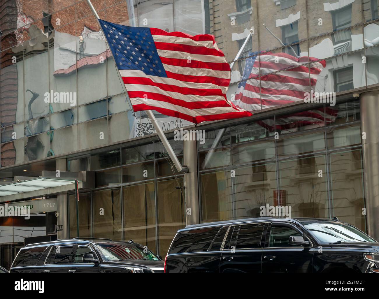 American flags flap in the wind on a Marriott Courtyard hotel in ...