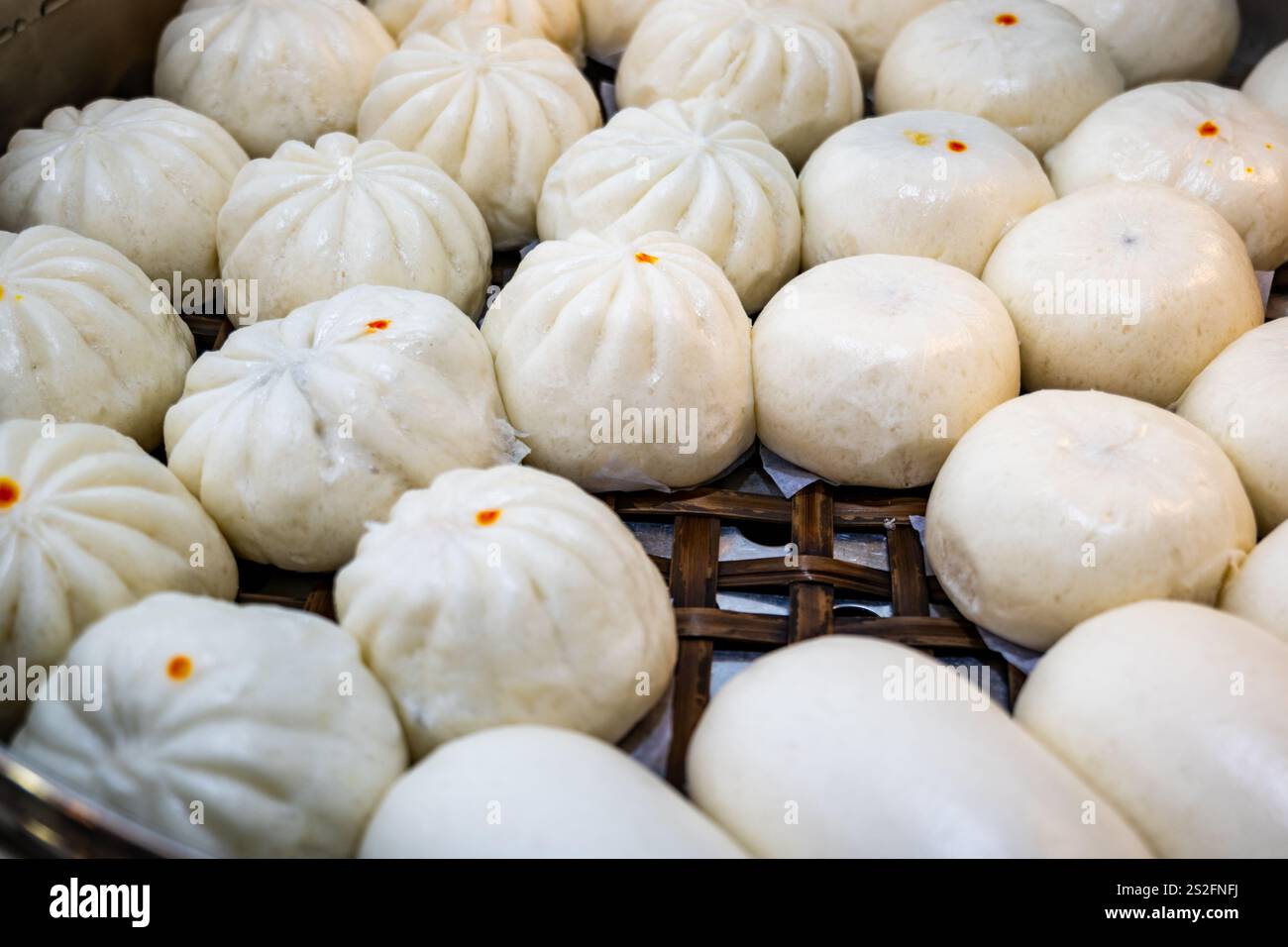 Chinese steamed buns in the steam pot displayed at the stall. Popular ...