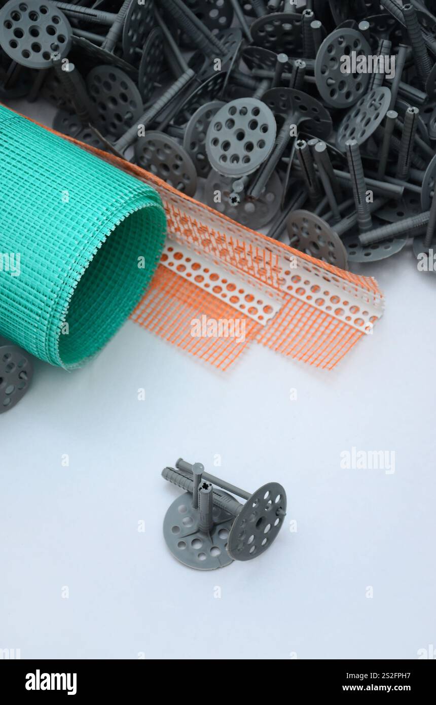 A set of construction items for the insulation of walls. Plastic dowels ...