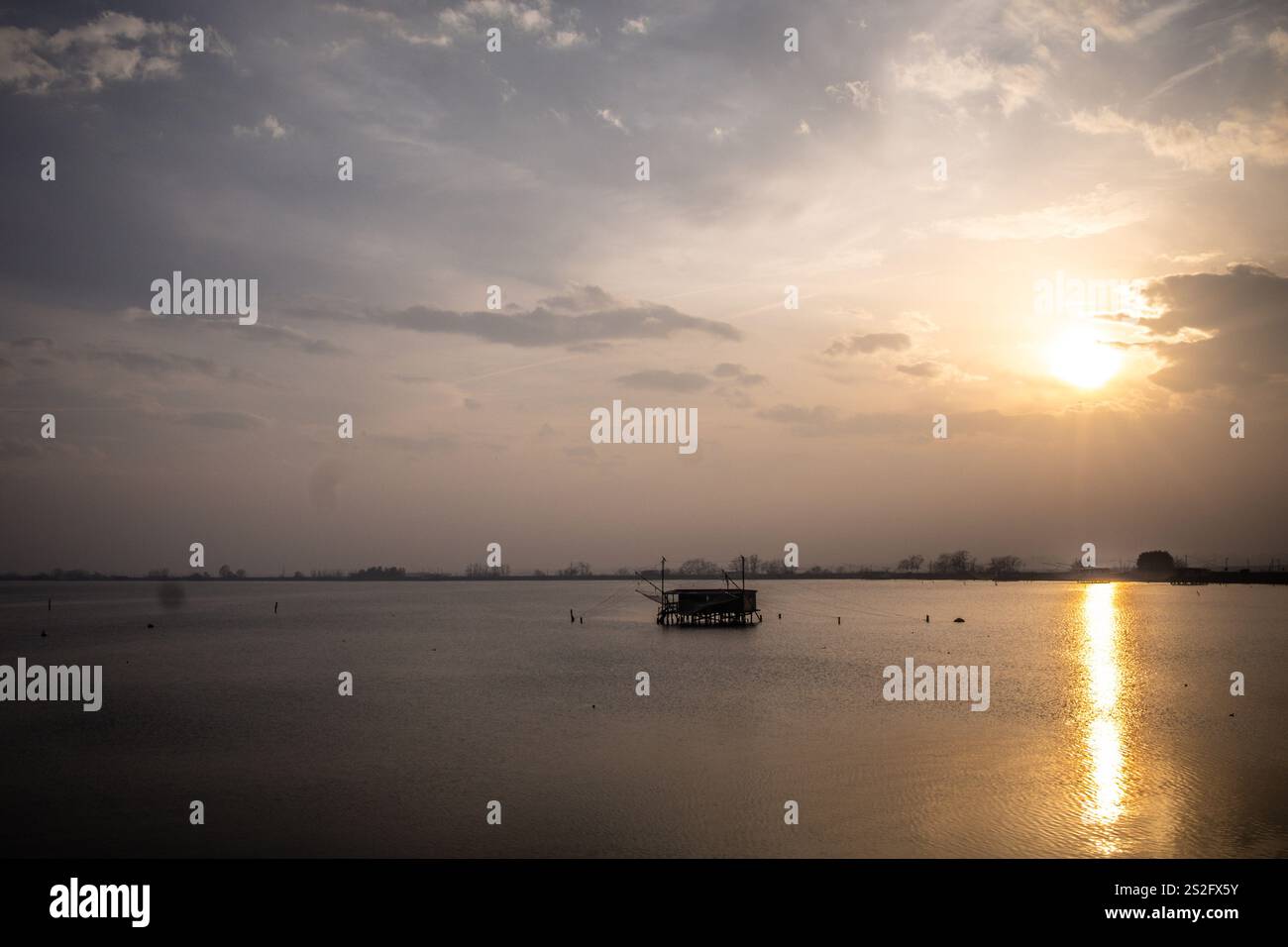 Comacchio, Italy - january 6 2025 - sunset over Comacchio bay Stock ...