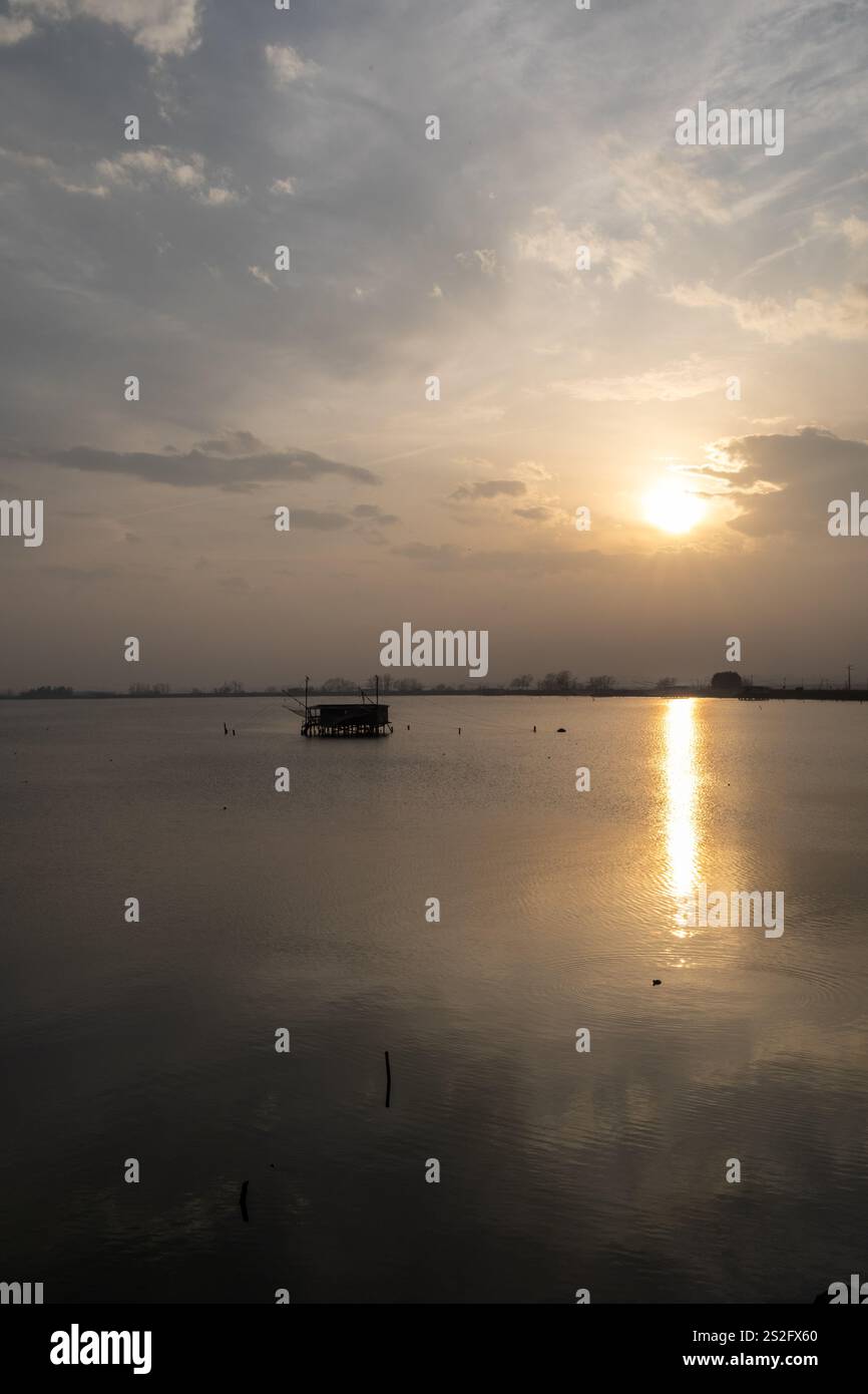 Comacchio, Italy - january 6 2025 - sunset over Comacchio bay Stock ...