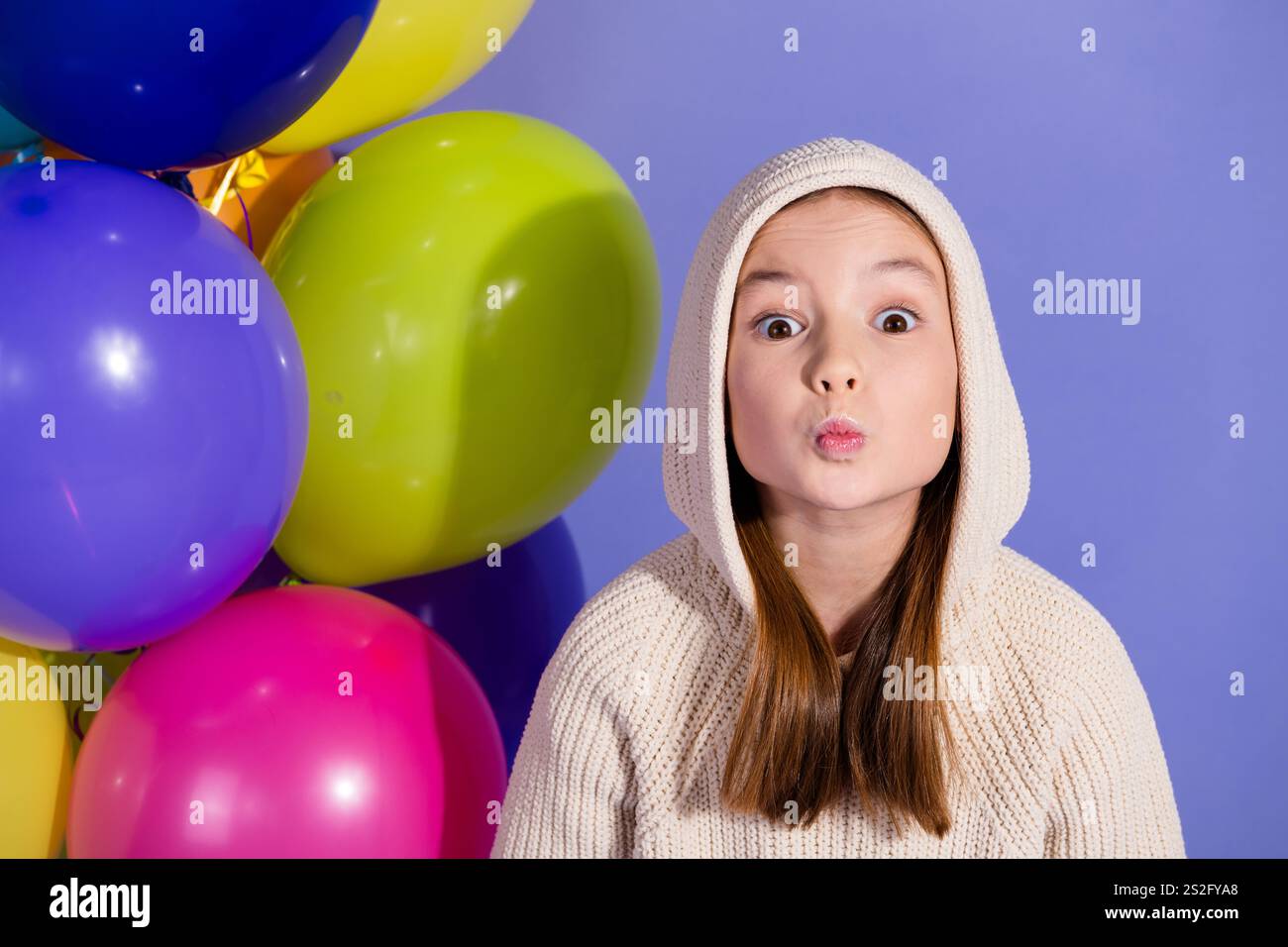 Cute preteen girl making a playful expression with balloons Stock Photo ...