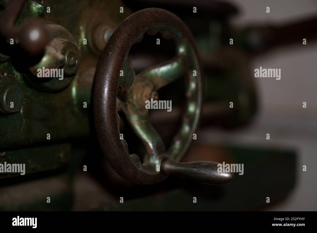 industry concept. rotating crank handle of old iron machine worn out in ...