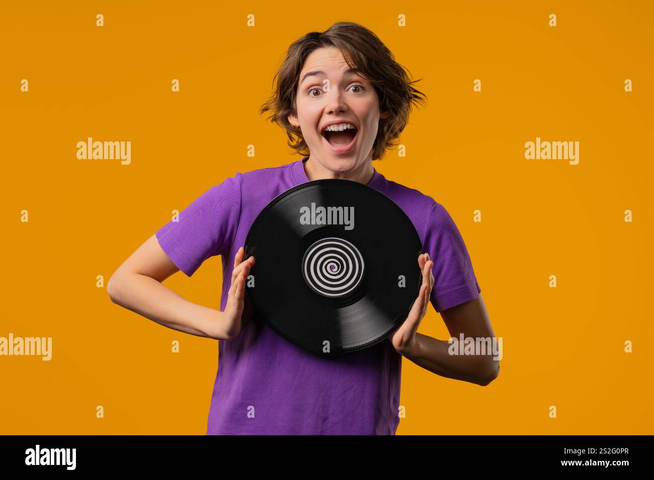 Pretty woman dancing with vinyl record disc on yellow. Hobby, music ...