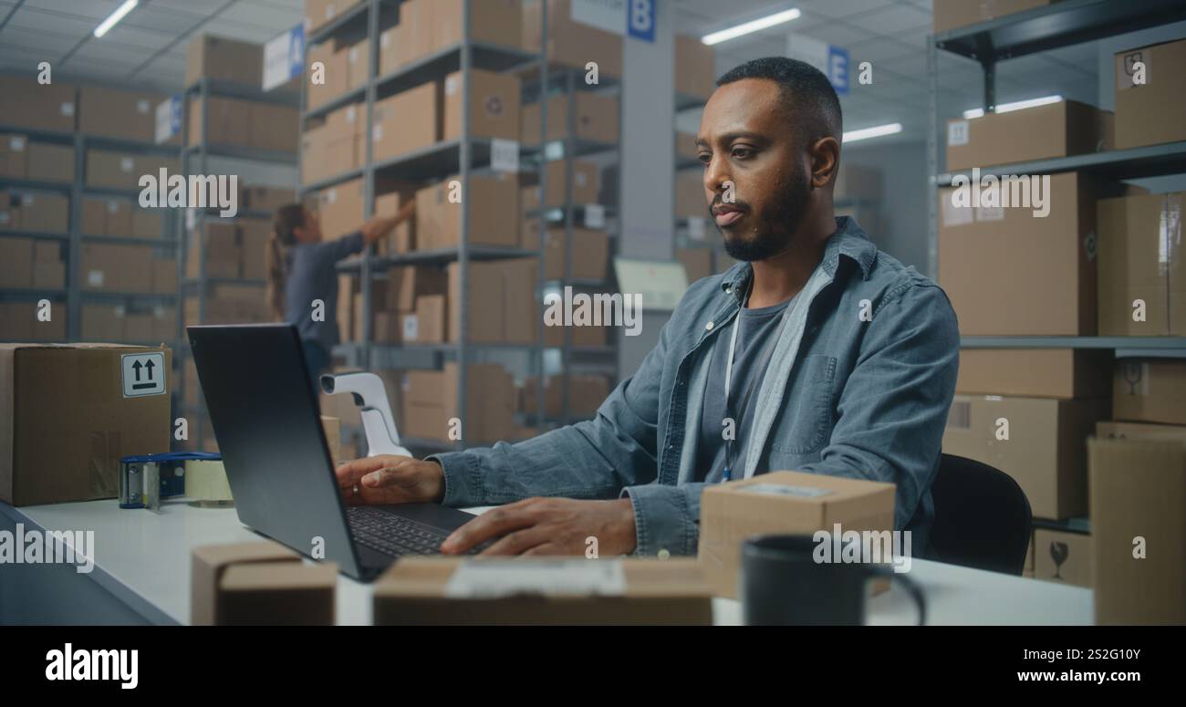 Postal service: African American logistics specialist scans parcel with barcode scanner ...
