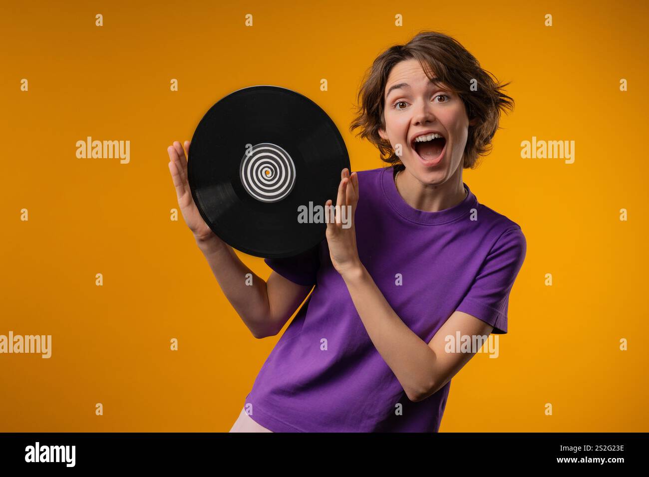 Pretty woman dancing with vinyl record disc on yellow. Hobby, music ...