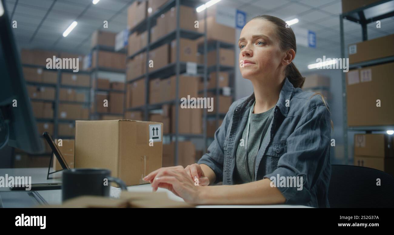 Female logistics specialist scans parcel with barcode scanner, checks ...