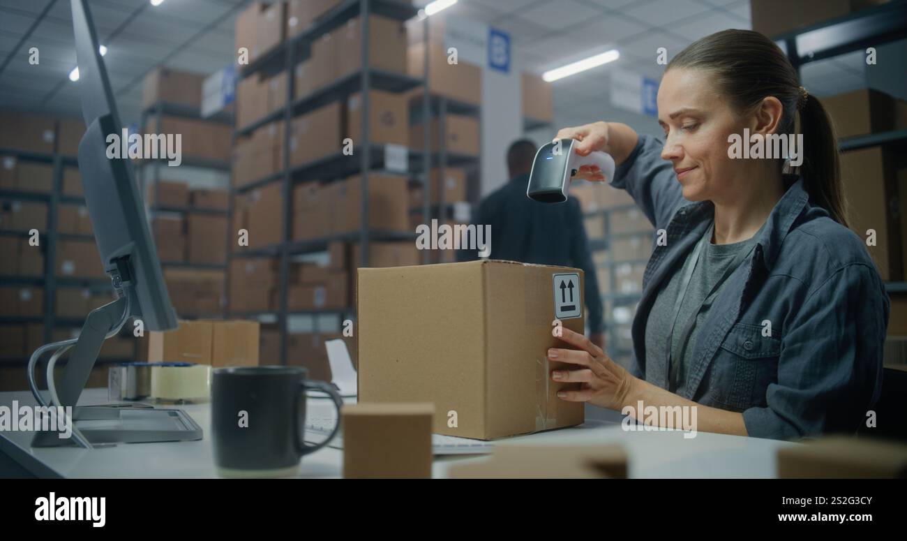 Female inventory manager scans parcel with barcode scanner, prepares ...