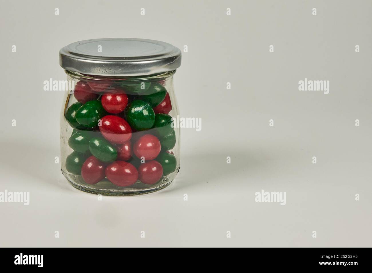 Chocolate dragees, covered with caramel of different colors, in a ...