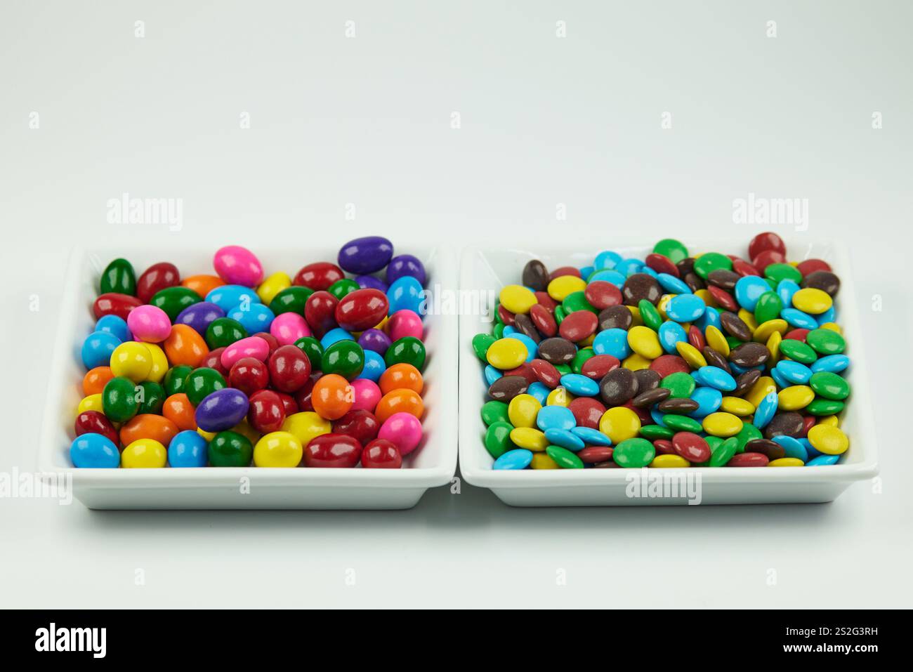 Chocolate dragees, covered with caramel of different colors, in a ...