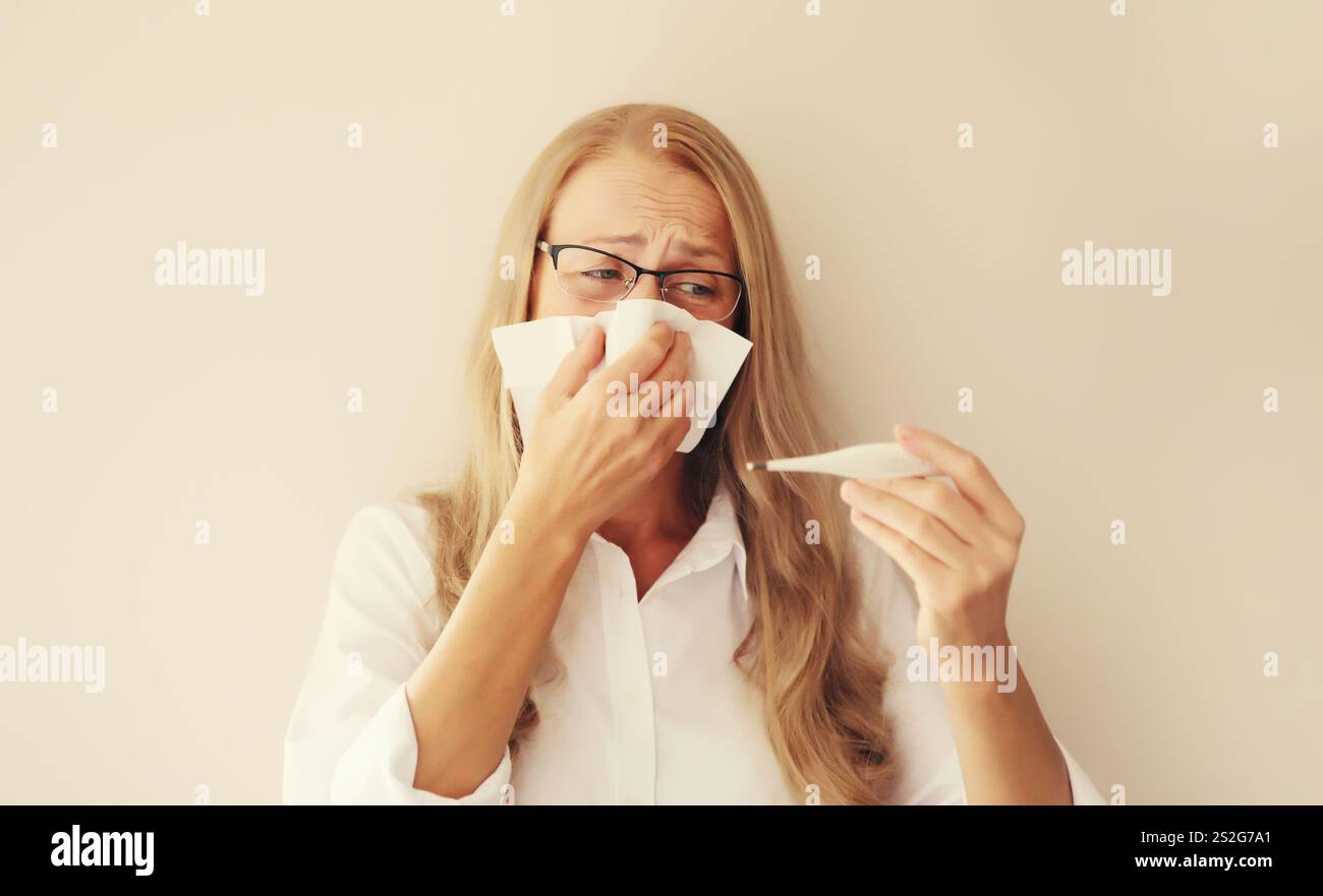 Sick upset caucasian woman employee sneezing blow nose using tissue and ...