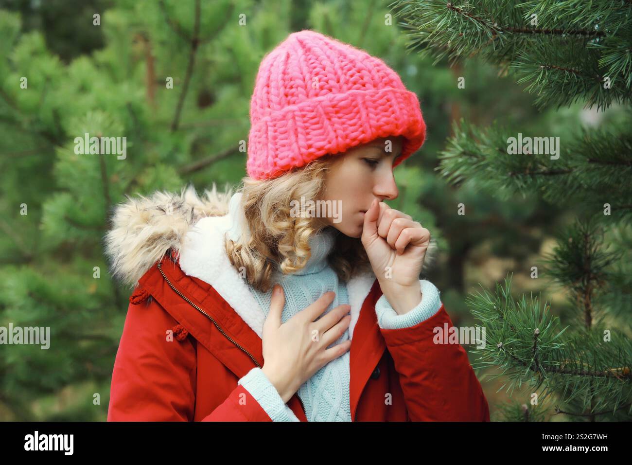 Cold and health, sick young woman coughing outdoors in winter park near ...