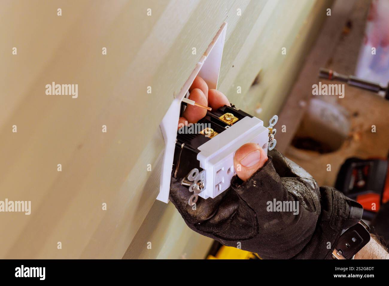 Electrician connects installs electrical outlets sockets on exterior ...