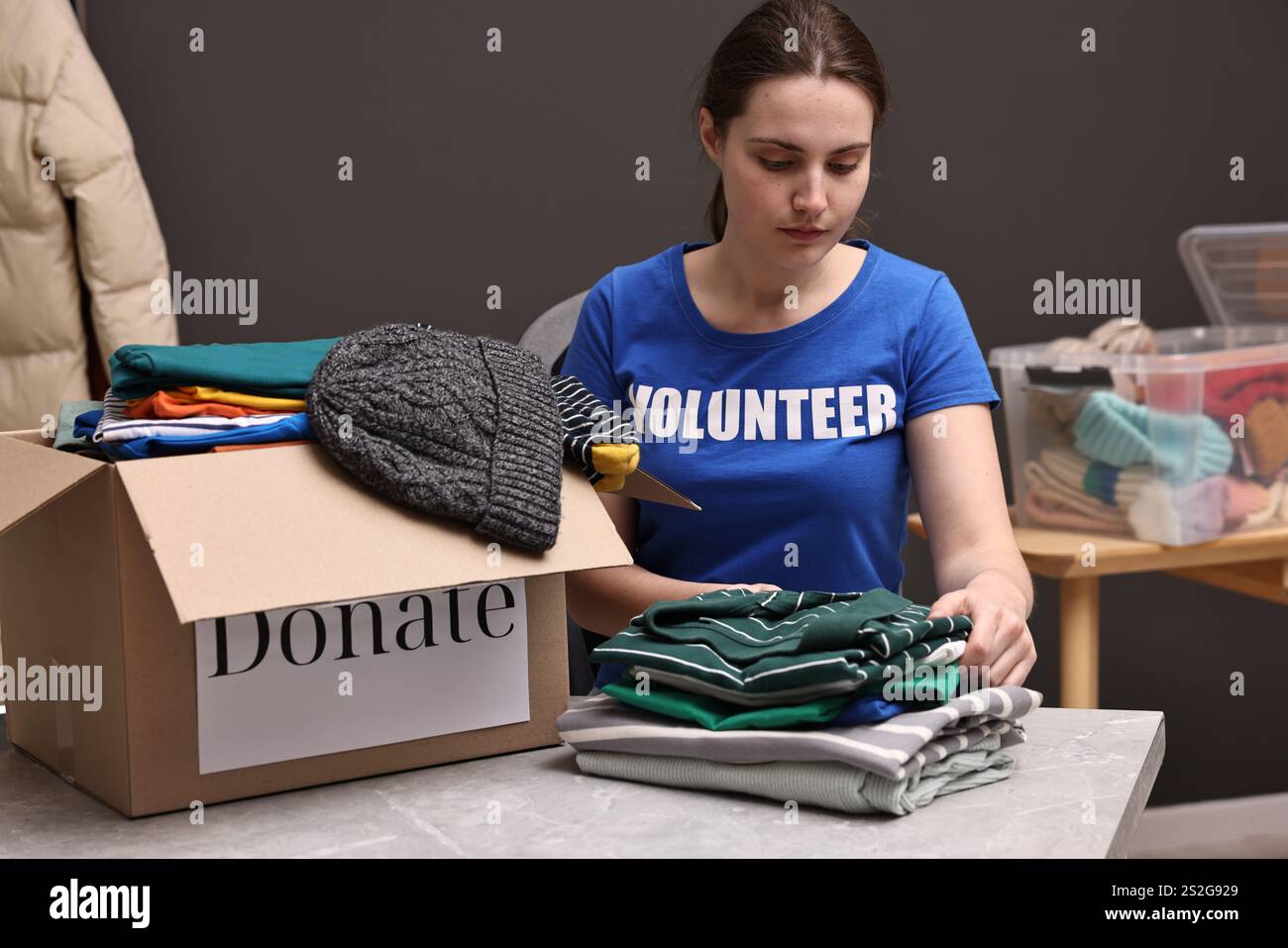 Woman volunteering donation center sorting hi-res stock photography and ...