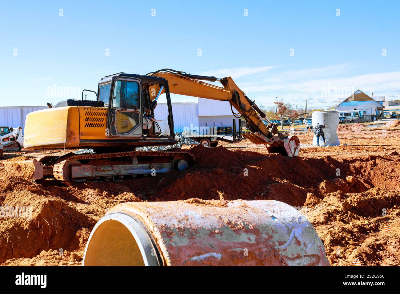 Heavy excavator operates at construction site, moving soil during ...