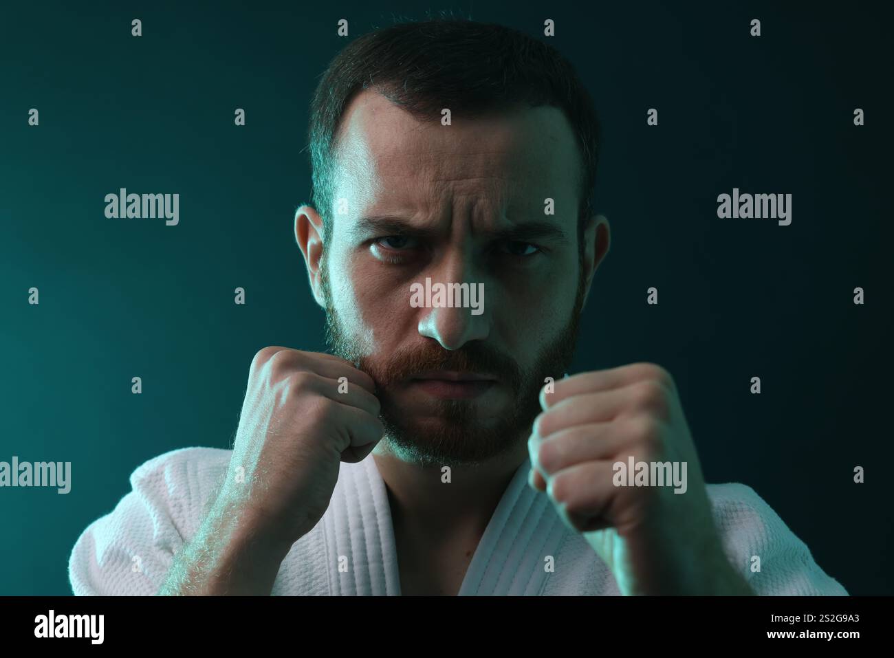 Karate fighter wearing uniform in color lights, closeup Stock Photo - Alamy
