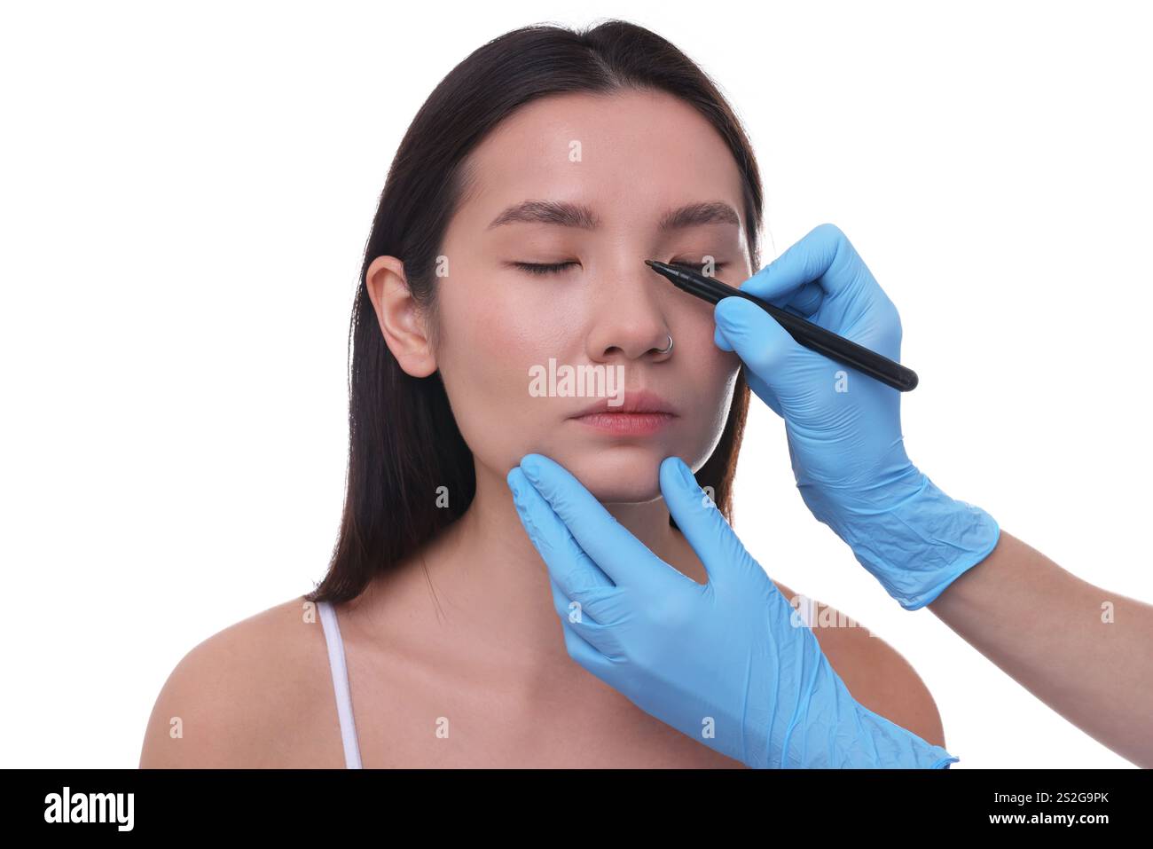 Doctor drawing marks on patient's nose for plastic surgery operation ...