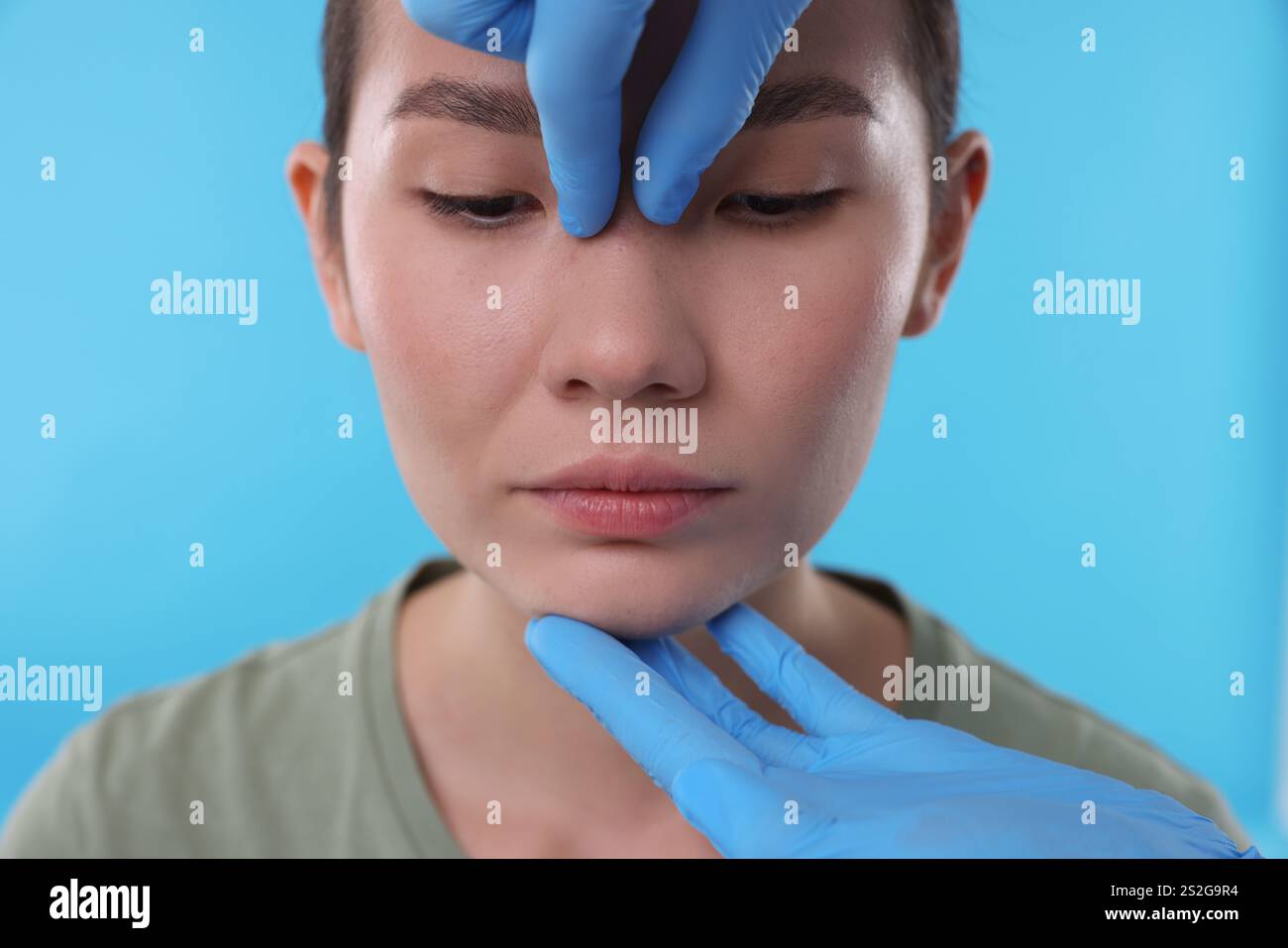 Doctor checking patient's nose before plastic surgery operation on ...