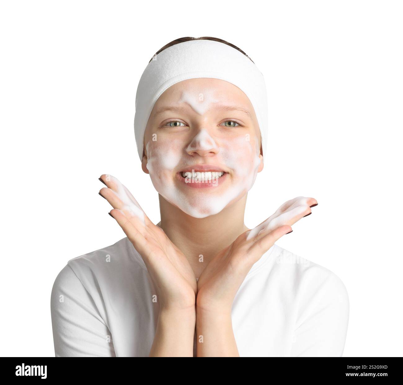 Teenage girl washing her face with cleanser on white background ...