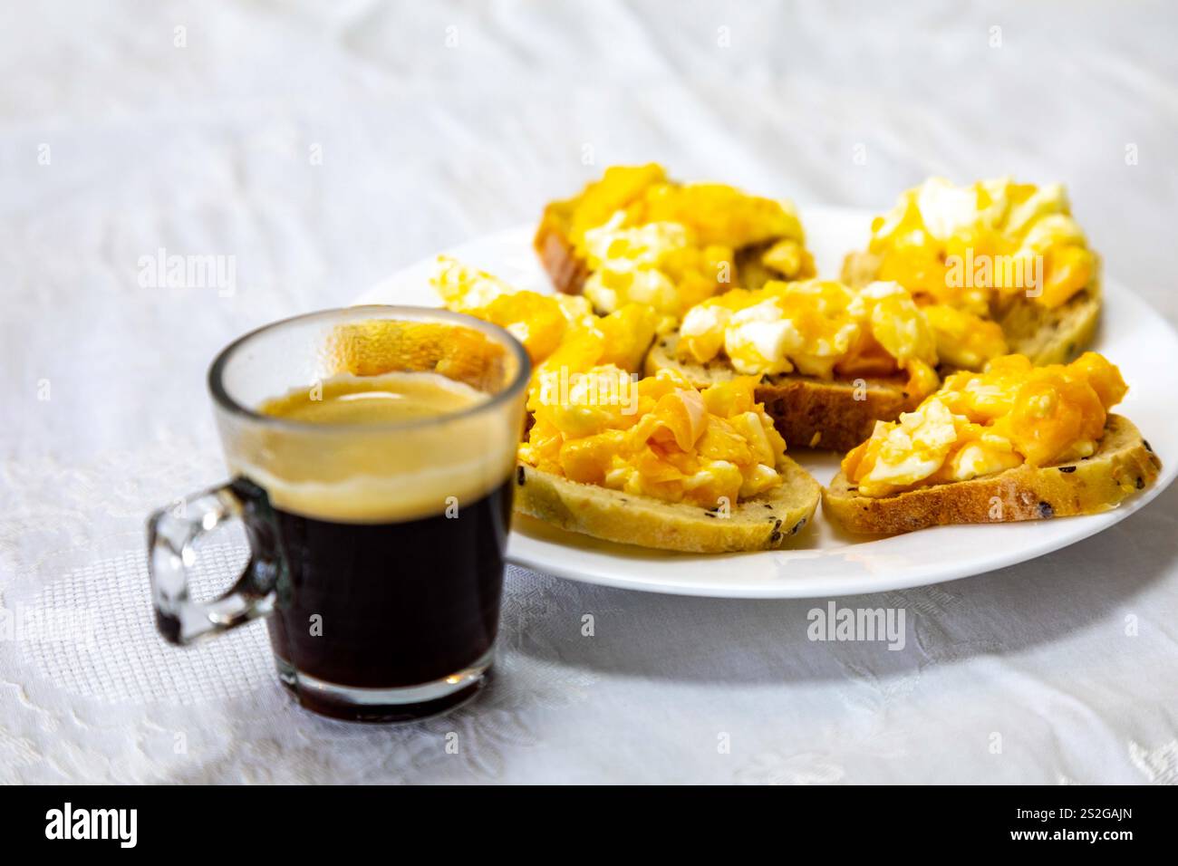 A minimalist breakfast classic, bread, scrambled eggs and coffee Stock ...