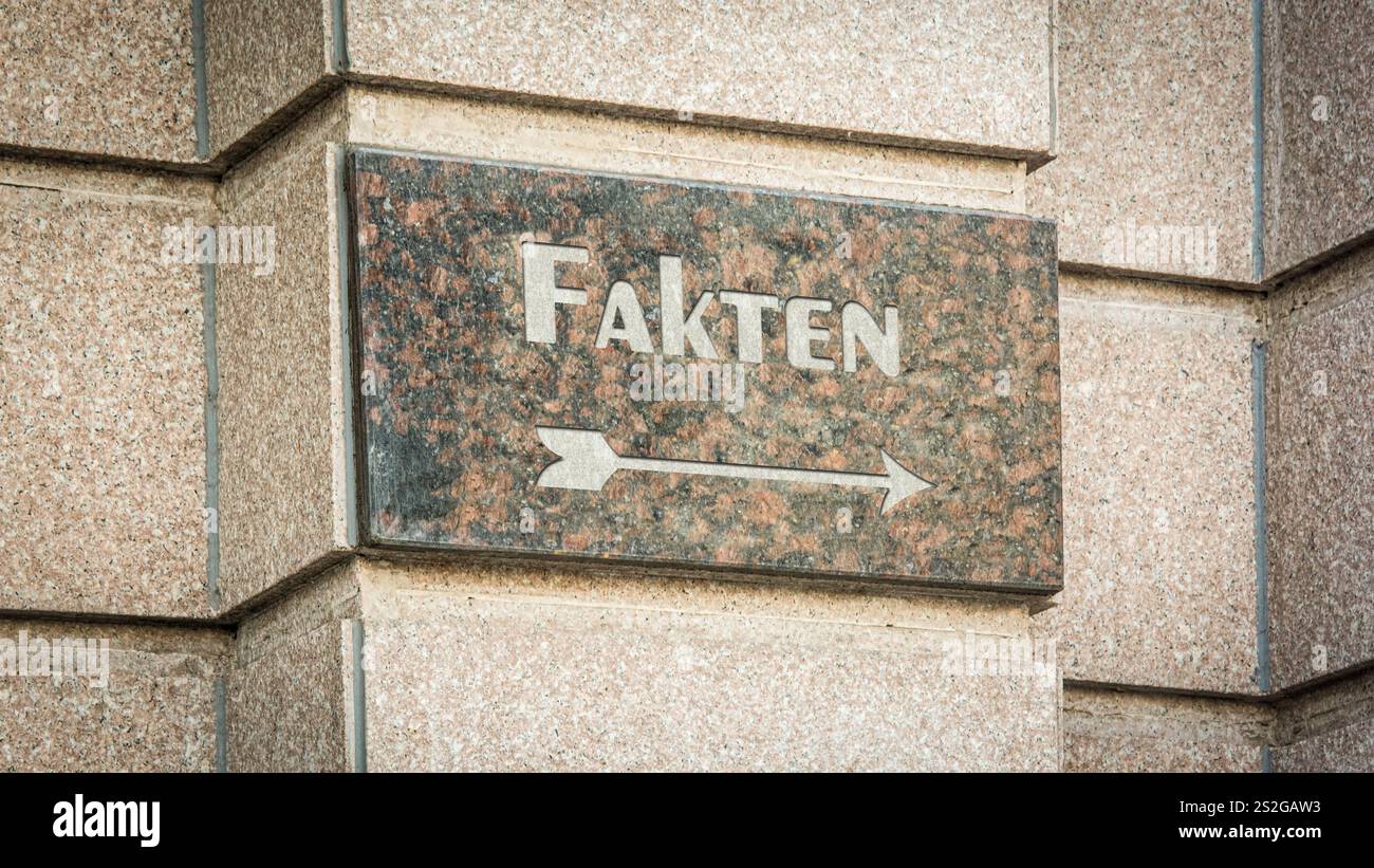 picture shows a signpost and a sign pointing to facts in german Stock ...