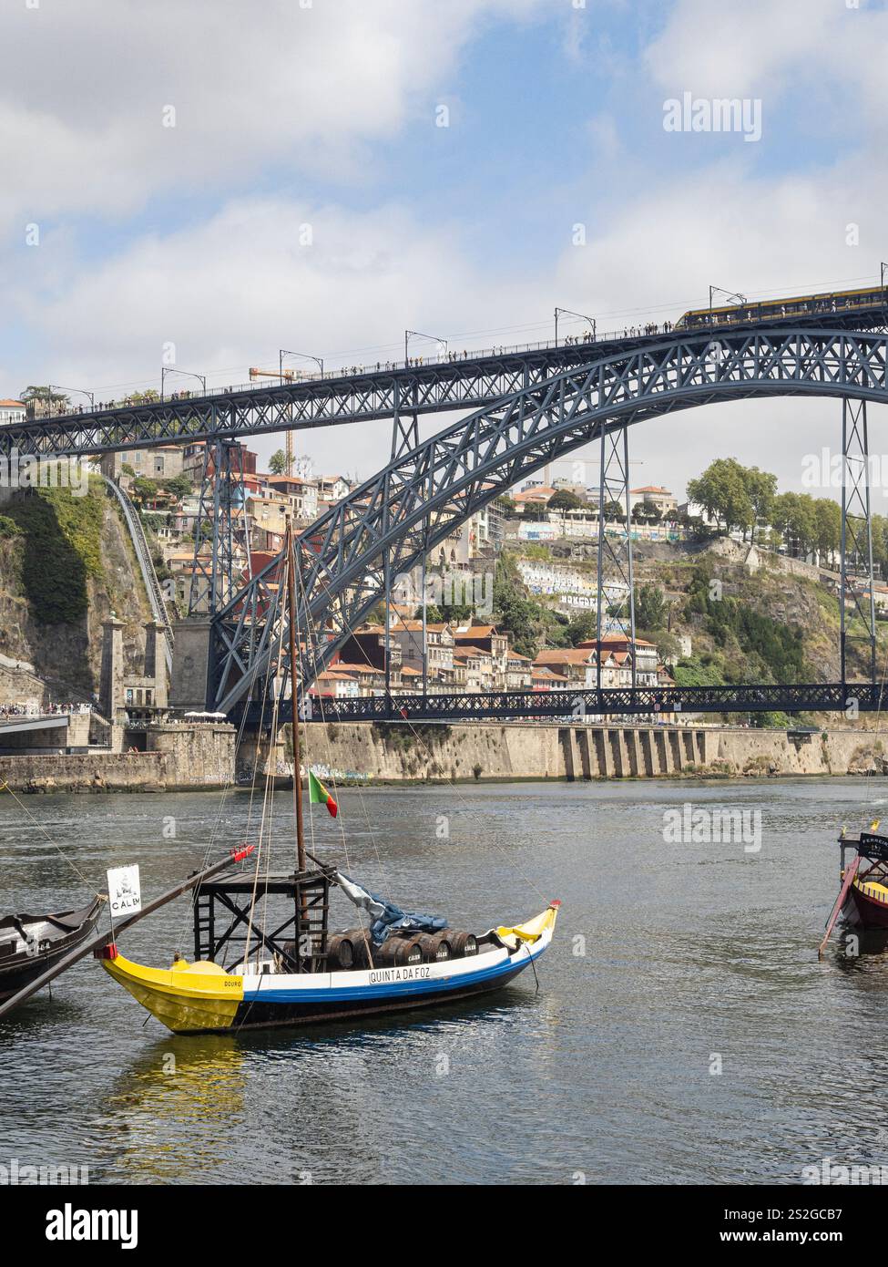 Traditional port boats and the Dom Luis bridge on the River Douro in ...