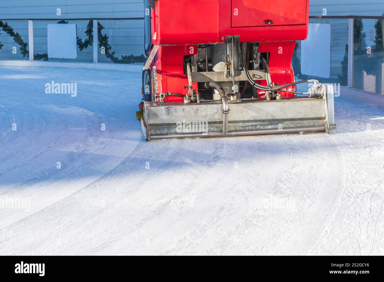 Close-up of a red ice resurfacer operating on an outdoor ice rink Stock ...