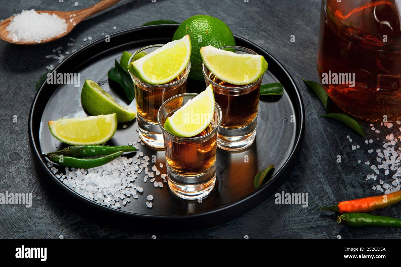 Tequila shots with lime and salt on gray background. Classic bar menu ...