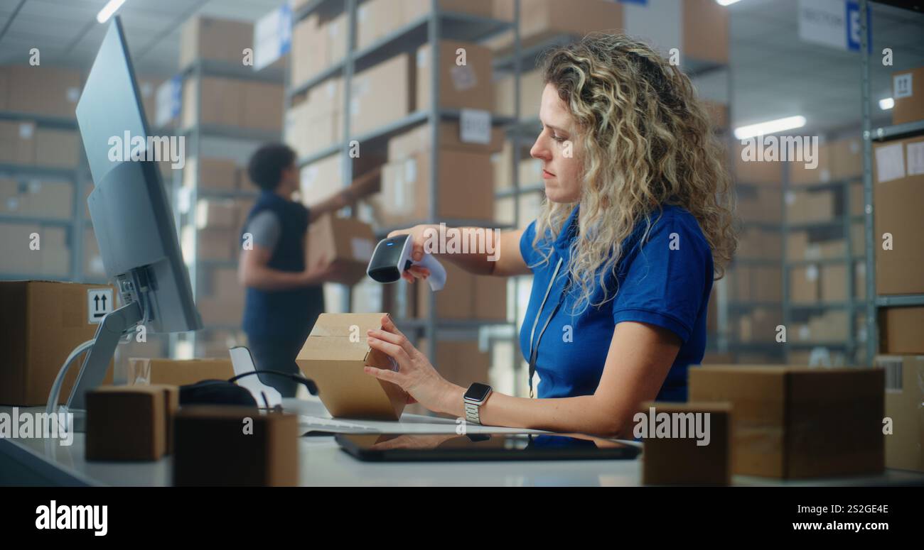 Female logistics specialist scans parcel using barcode scanner, checks data using computer ...