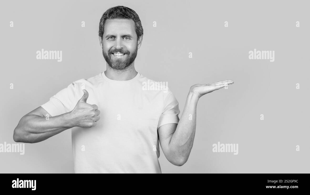 happy man presenting advertisement on background, thumb up. man ...