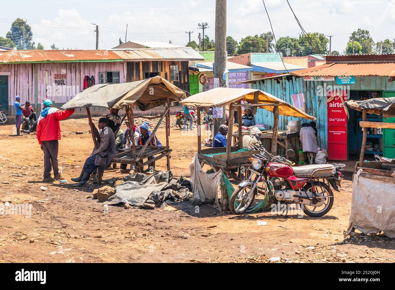 Street scene with local men on motorbikes, Kenya Stock Photo - Alamy