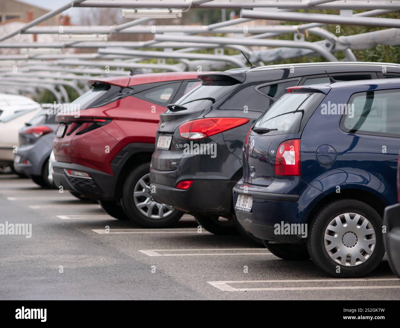 Cars on free parking lot near big supermarket. Canopies to limit the ...