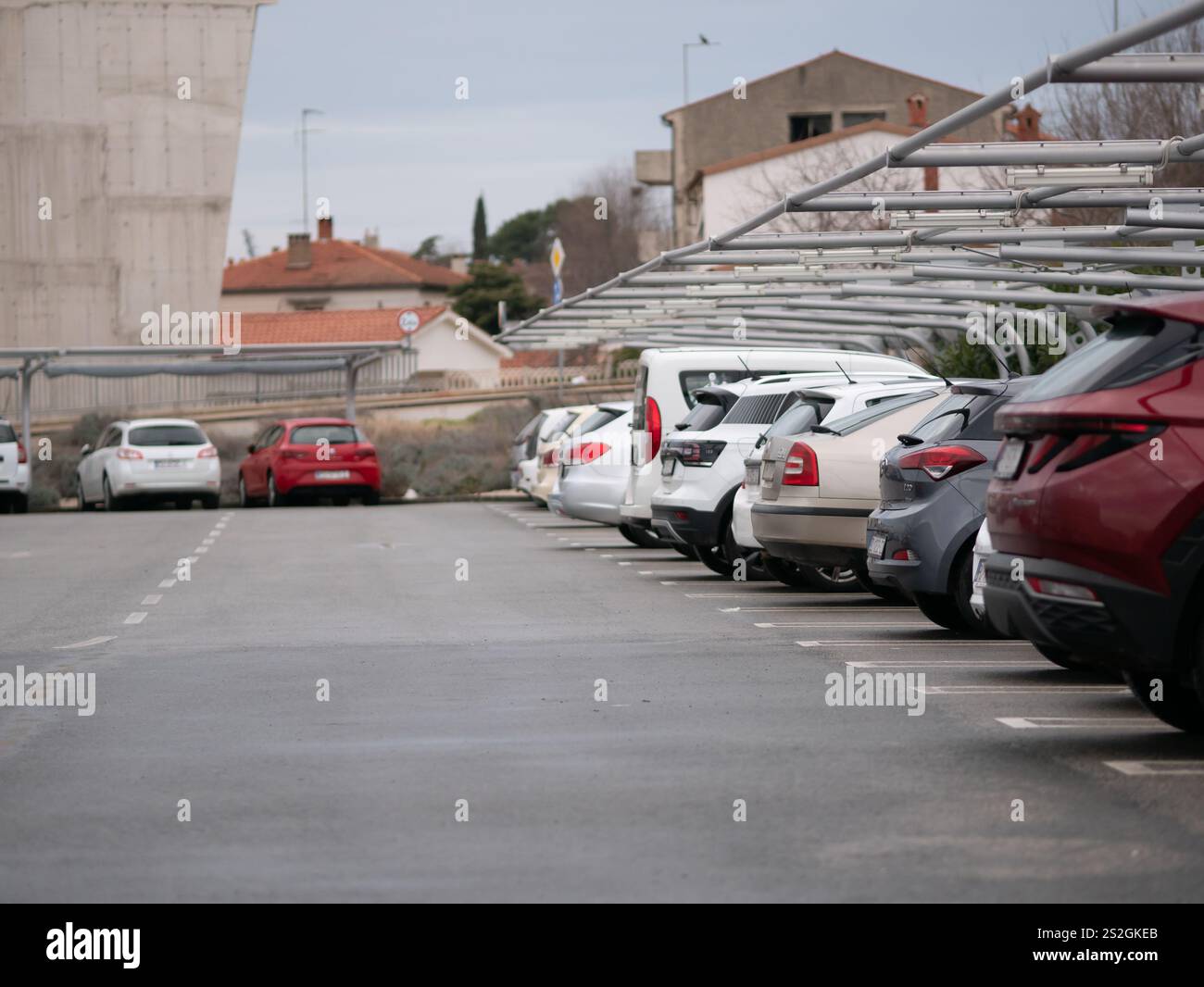 Cars on free parking lot near big supermarket. Canopies to limit the ...