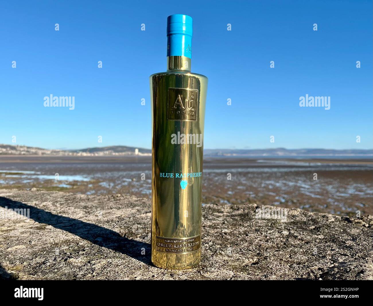 Au Vodka Blue Raspberry, with Swansea Bay in the background. The ...