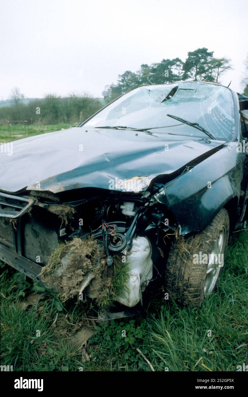 A car that has collided with a tree and over turned into a field Stock ...
